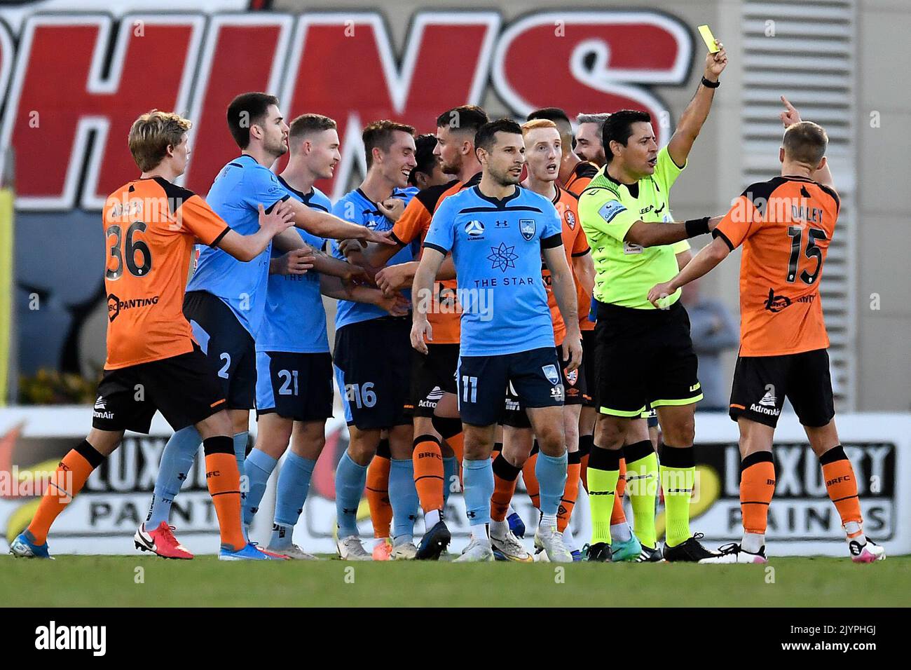 Jesse Daley of the Roar (far right) is shown a yellow card by referee ...