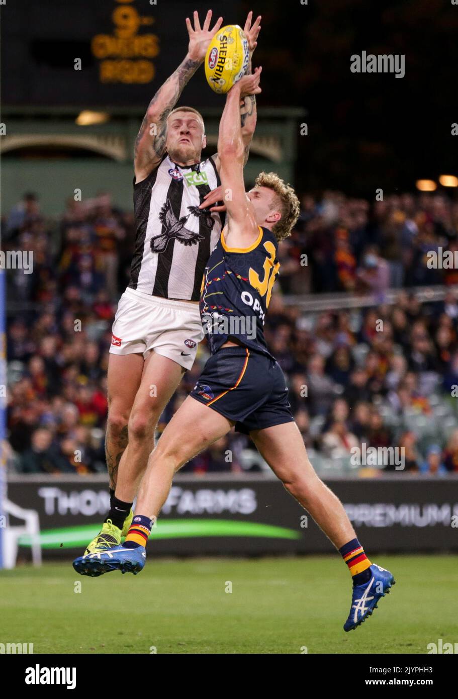 Jordan De Goey of the Magpies clashes with Andrew McPherson of the ...
