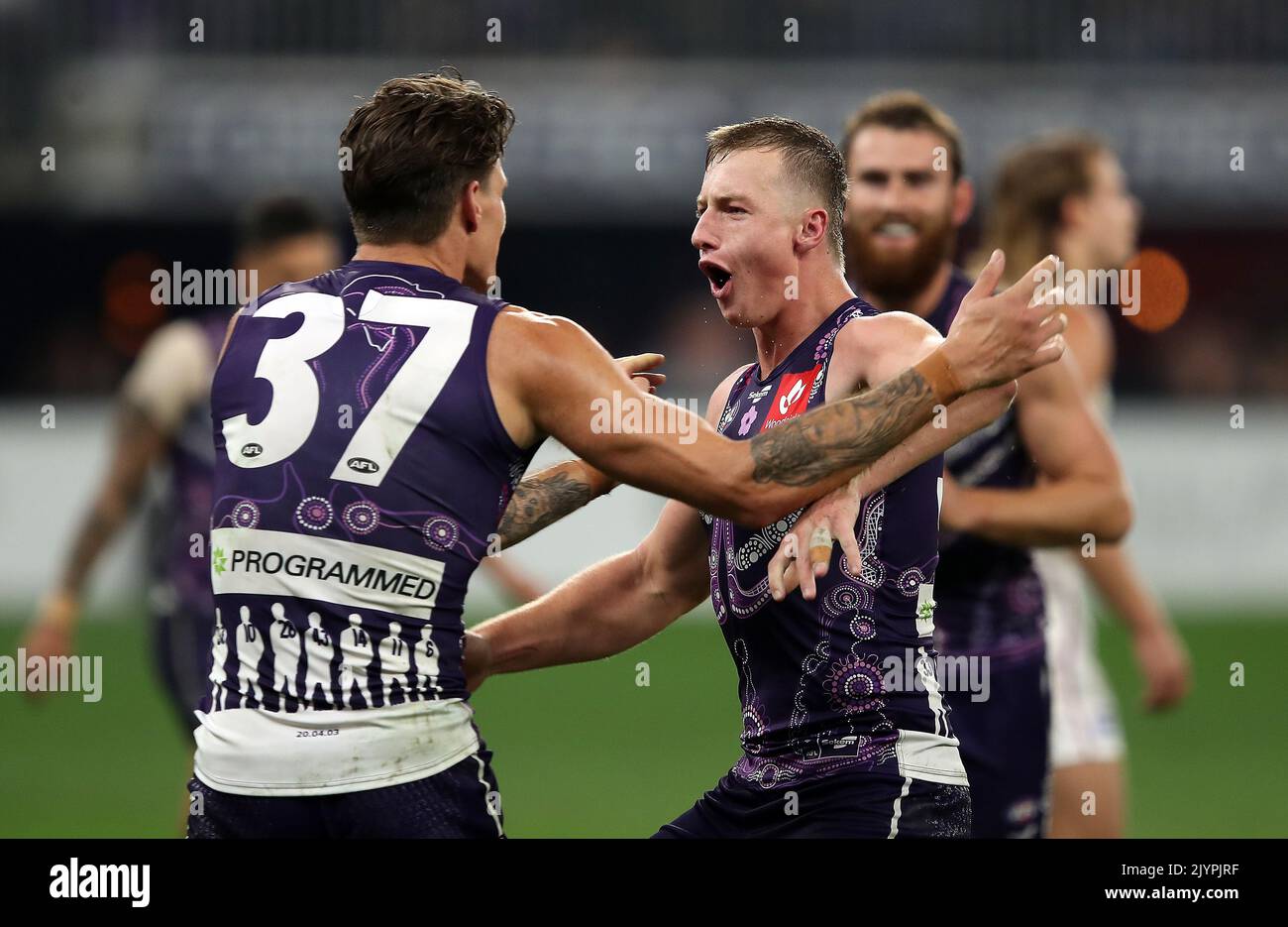 Josh Treacy of the Dockers celebrates kicking a goal with Rory Lobb of ...