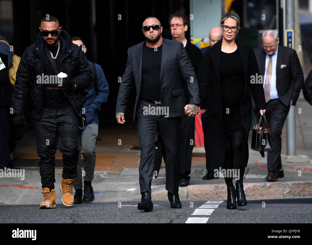 Joshua John Lucey (centre) arrives at the District Court in Brisbane ...