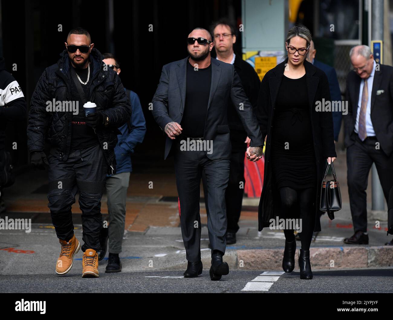 Joshua John Lucey (centre) arrives at the District Court in Brisbane ...