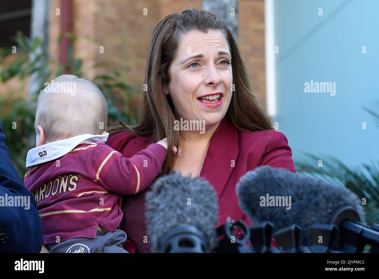 Member for Lilley, Anika Wells speaks to the media while holding one of ...