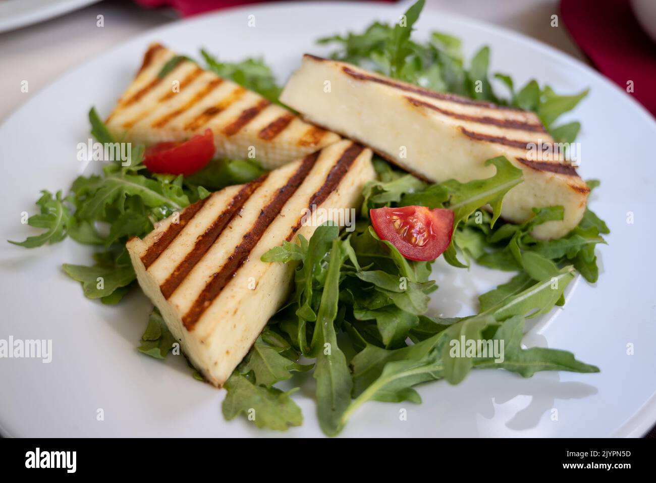 Three roasted slices of Greek Halloumi cheese, a semi-hard, unripened ...