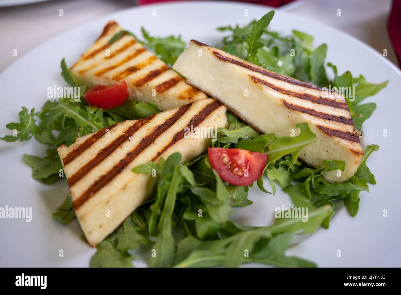 Three roasted slices of Greek Halloumi cheese, a semi-hard, unripened ...