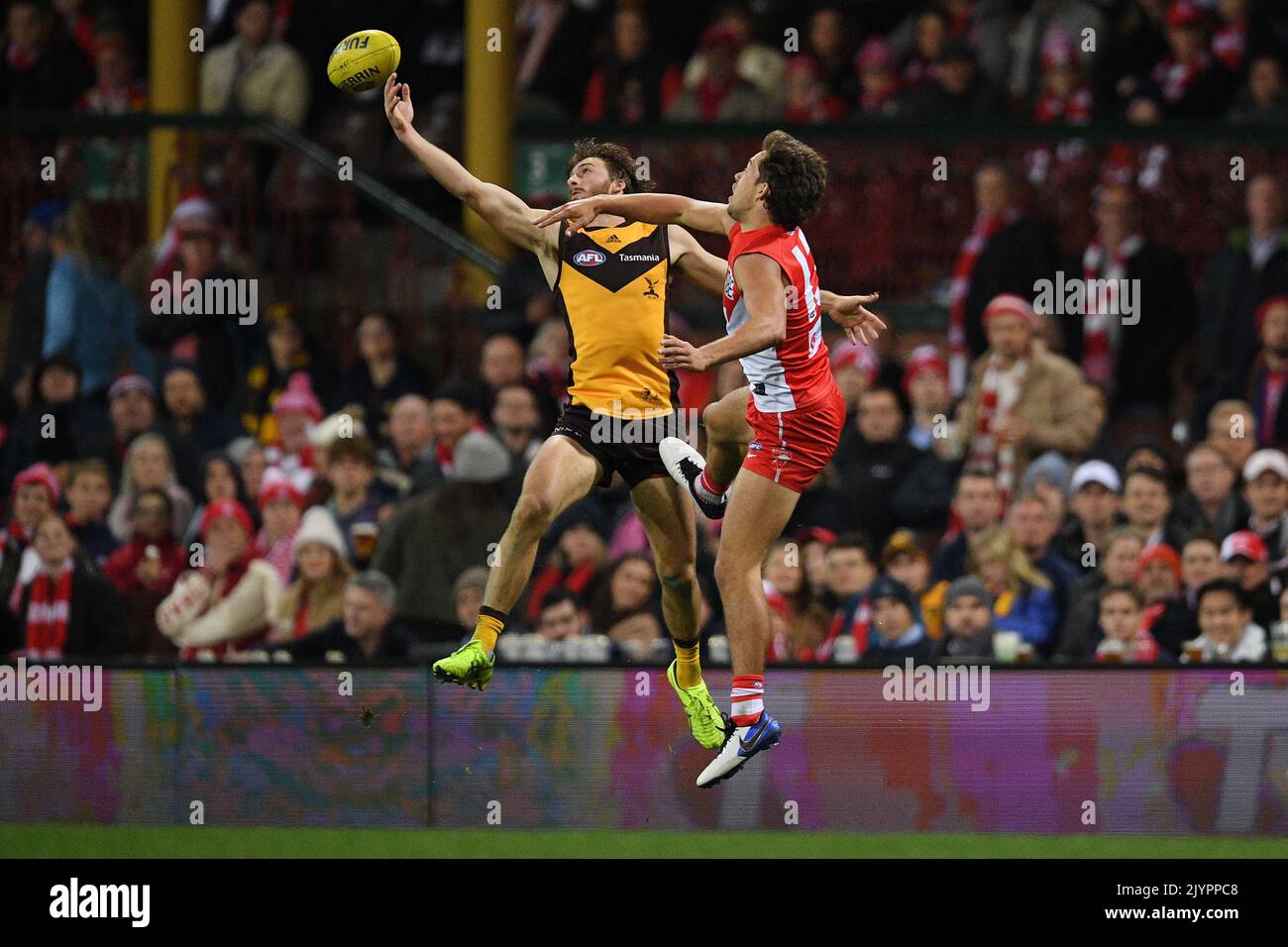 Tom Phillips of the Hawks and Oliver Florent of the Swans during the ...