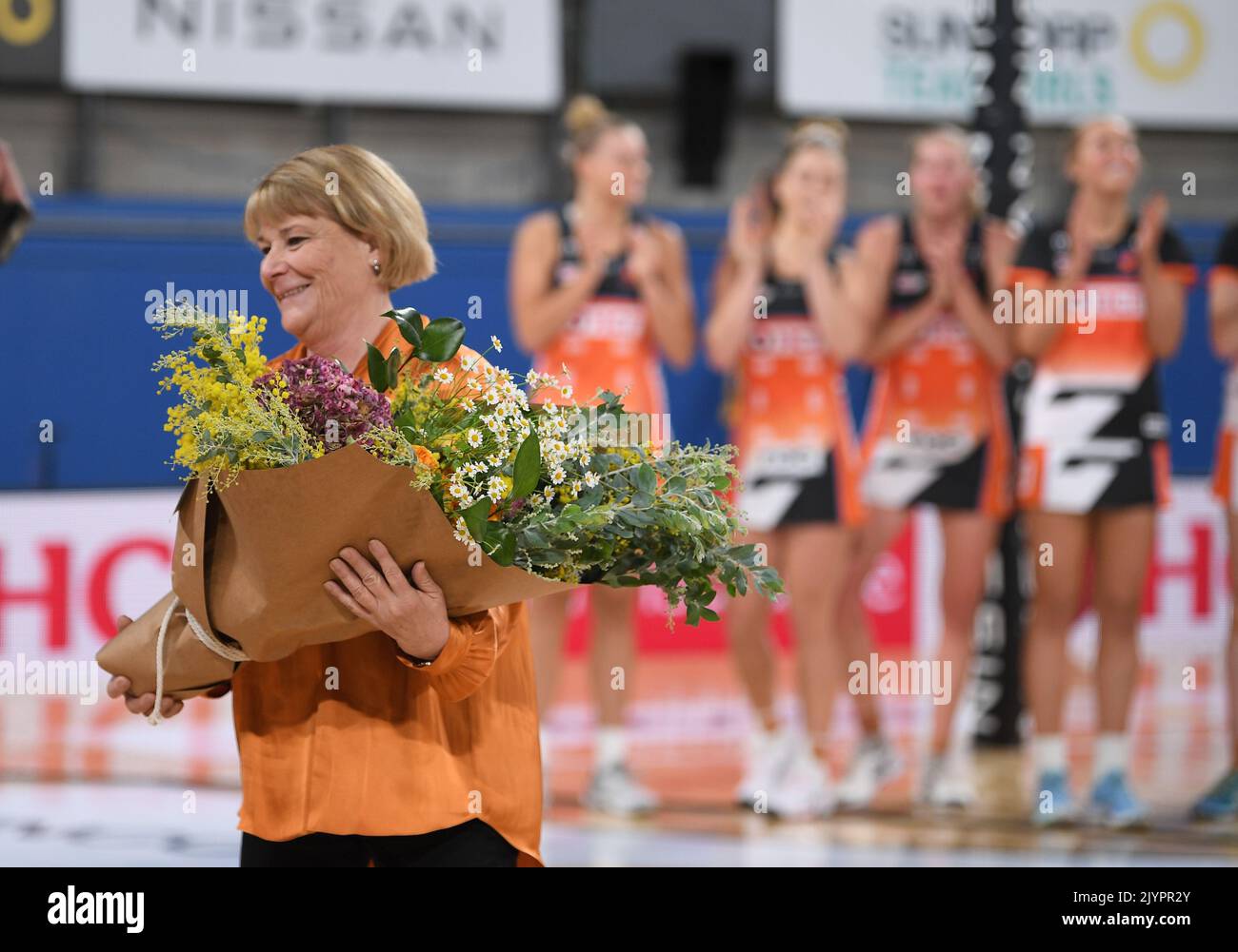 Giants Coach Julie Fitzgerald is presented with flowers after the Round ...
