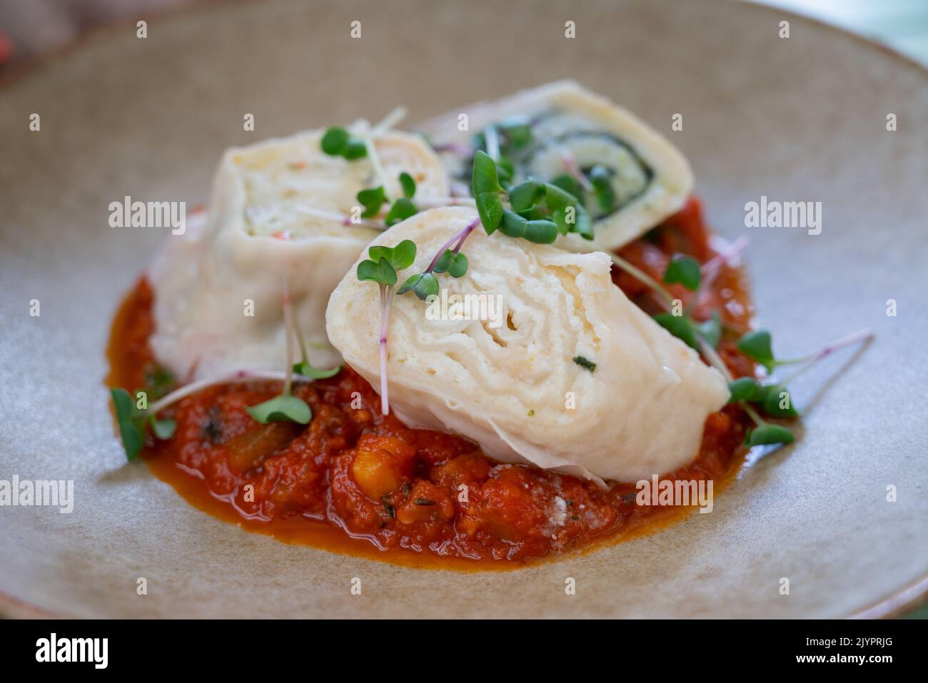 Three pieces of "truklji", Slovenian cheese dumplings, a traditional ...