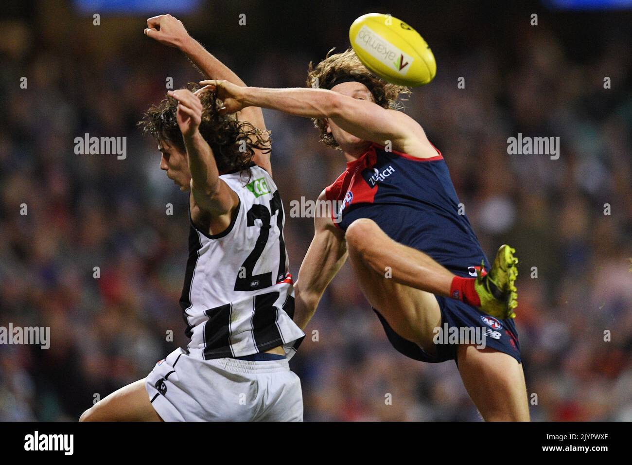 Caleb Poulter of the Magpies and Ed Langdon of the Demons during the ...