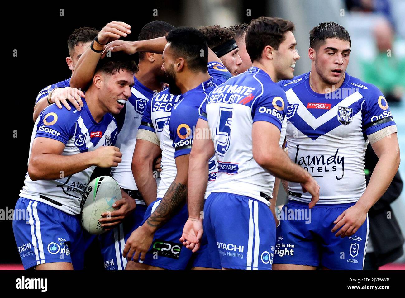 Jake Averillo of the Bulldogs celebrates scoring a try with team mates ...