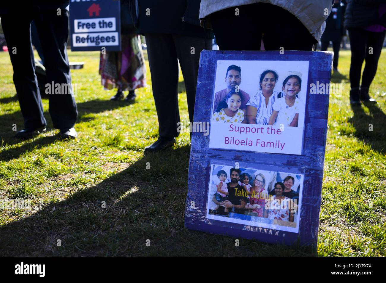 Protesters show signs at a rally asking for a permanent resettlement ...