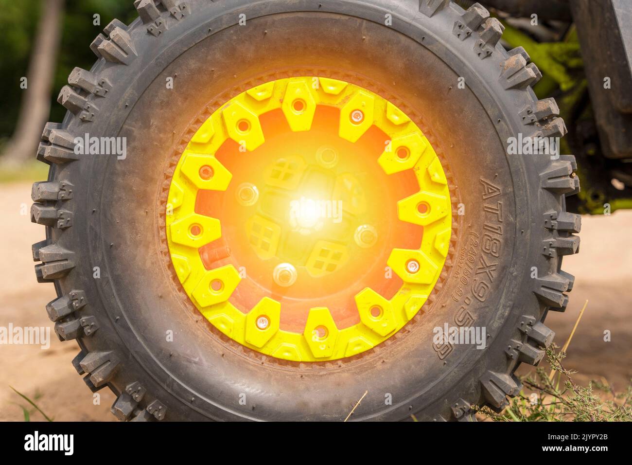 Close-up of the ATV wheel on sandy ground Stock Photo - Alamy