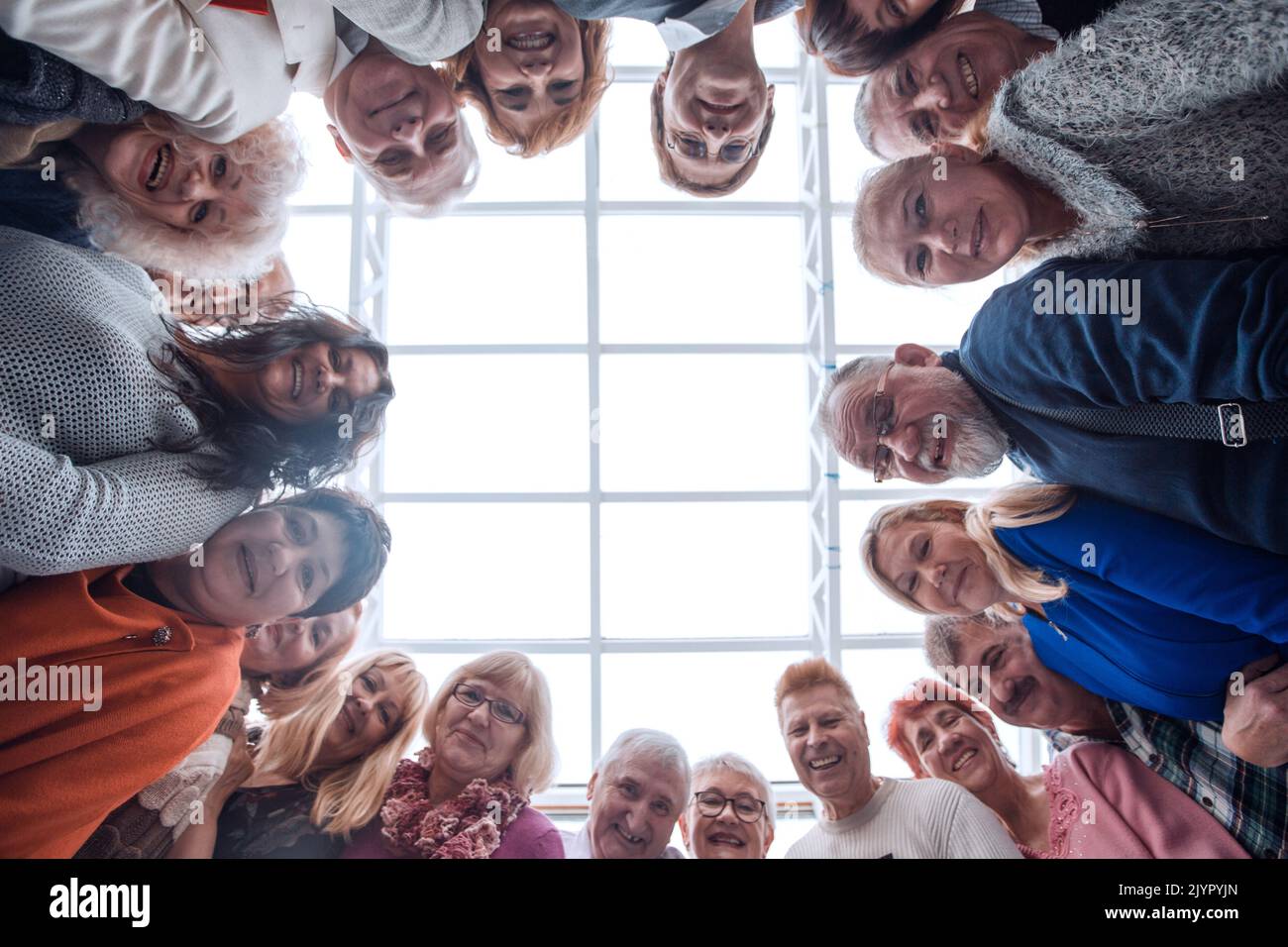 Happy people looking down at camera Stock Photo - Alamy