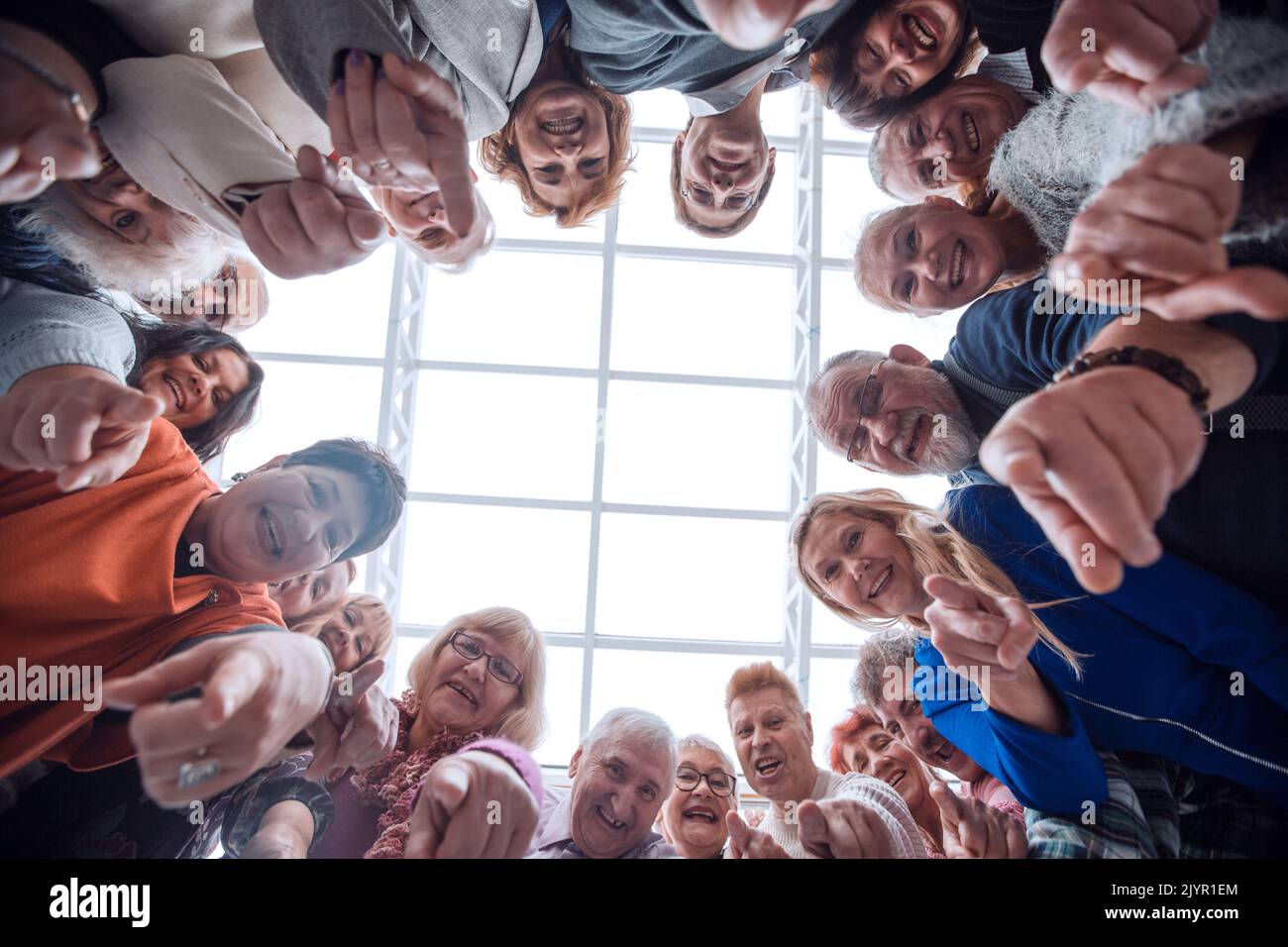 Group of smiling people pointing at the camera Stock Photo - Alamy