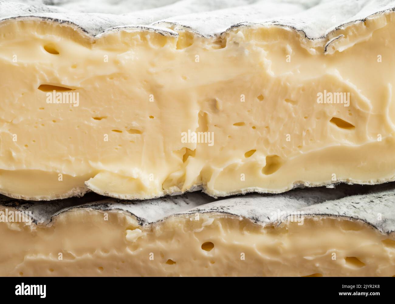 Closeup of cut brazilian artisan Lua Cheia cheese showing creamy ...