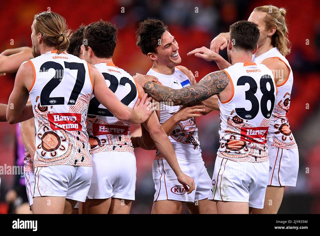 Isaac Cumming of the Giants celebrates with teammates after kicking a ...