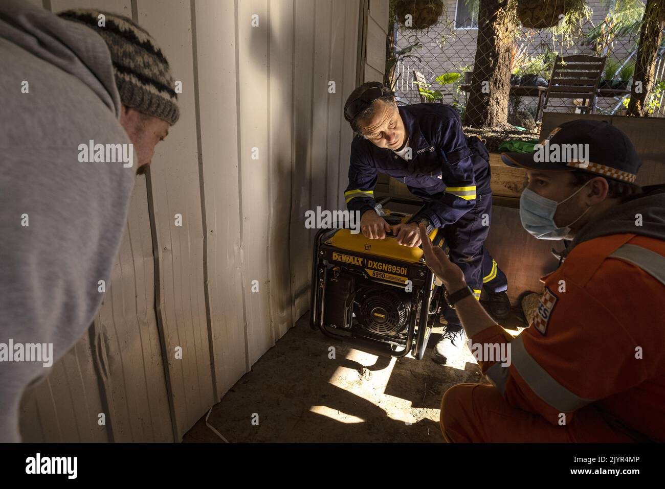 SES and Energysafe Victoria members are seen delivering a generator to ...