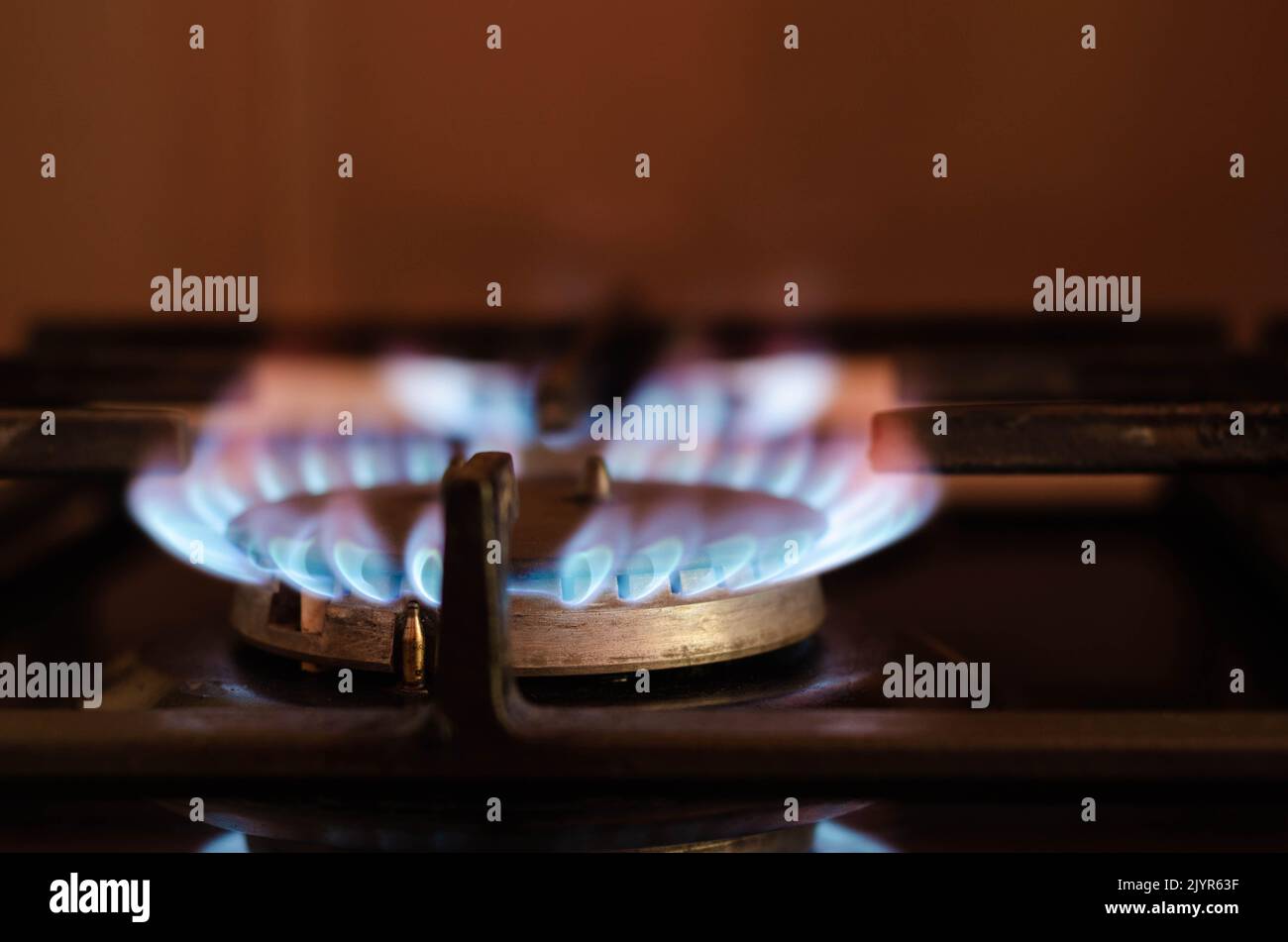 Closeup shot of blue fire from domestic kitchen stove top. Gas cooker ...