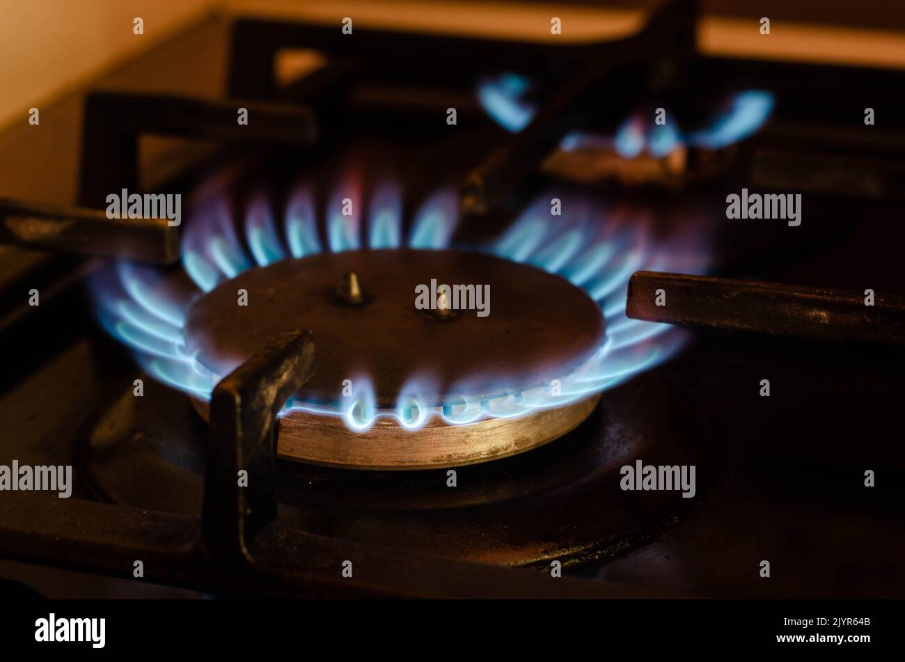 Closeup shot of blue fire from domestic kitchen stove top. Gas cooker ...