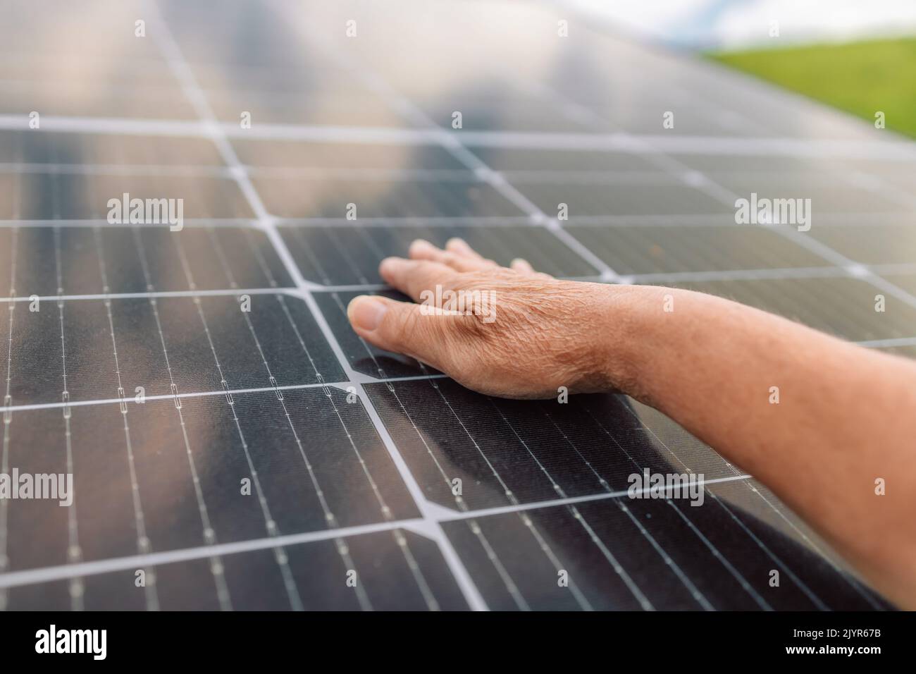 Close up on female hand touching stroking photovoltaic solar panels in ...