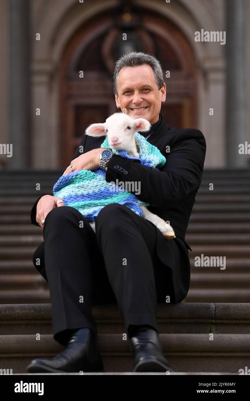 Animal Justice Party MP Andy Meddick poses for a photograph with a lamb ...