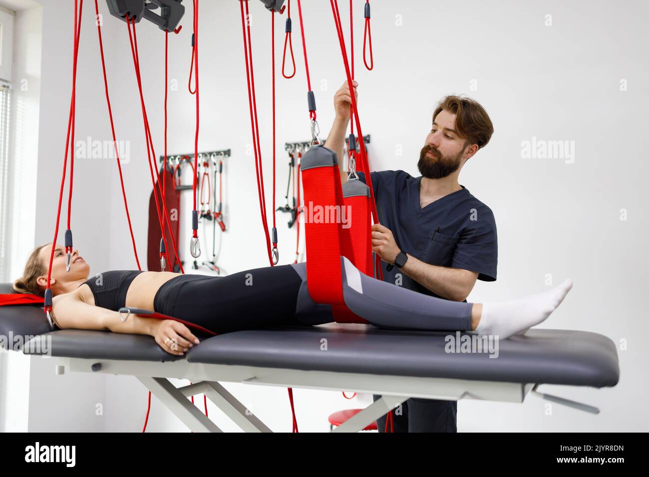 Physiotherapist doctor preparing a female patient for a neuromuscular ...