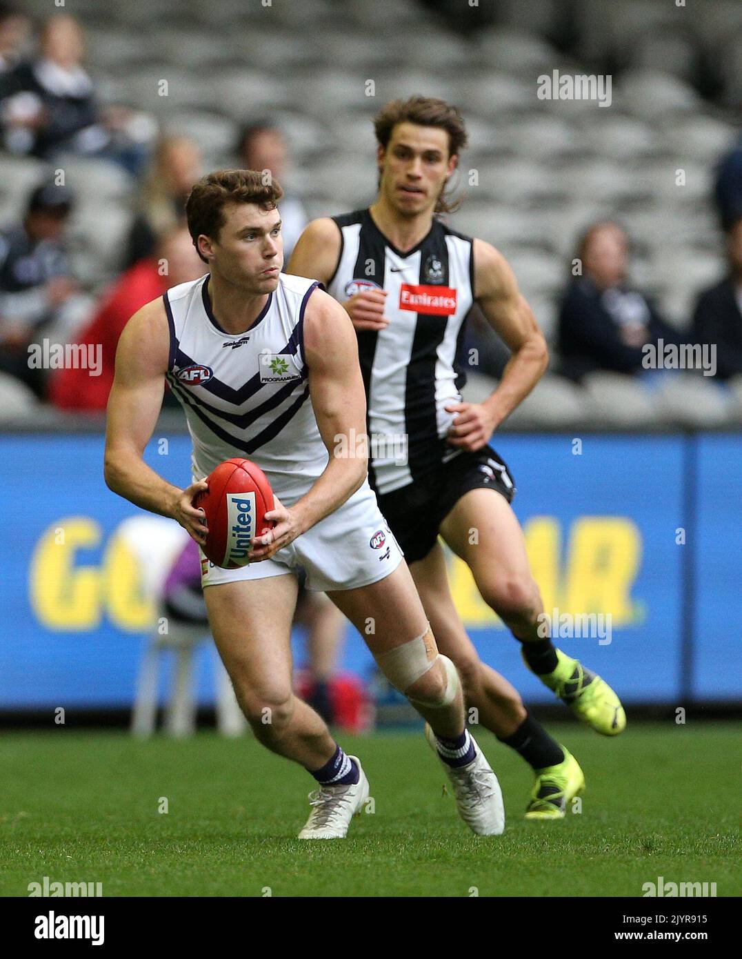 Blake Acres of the Dockers under pressure from Caleb Poulter of the ...