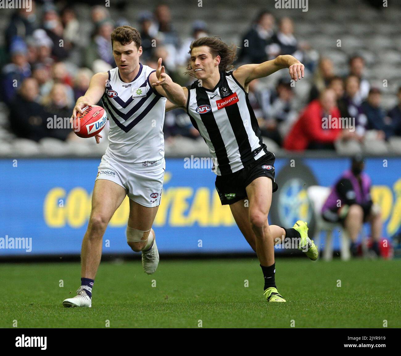 Blake Acres of the Dockers under pressure from Caleb Poulter of the ...