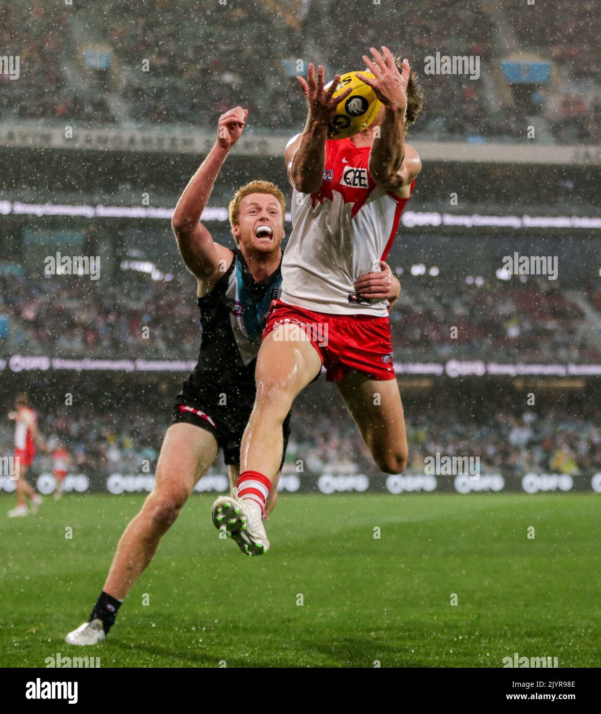 Callum Mills of the Swans attempts to mark the ball under pressure from ...