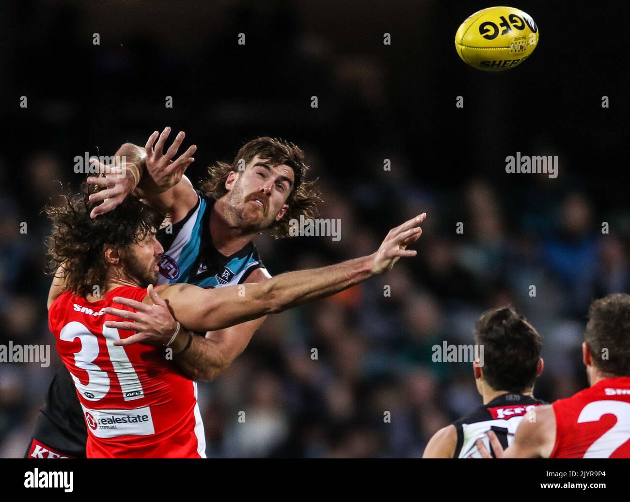 Tom Hickey of the Swans and Scott Lycett of the Power compete in a ruck ...
