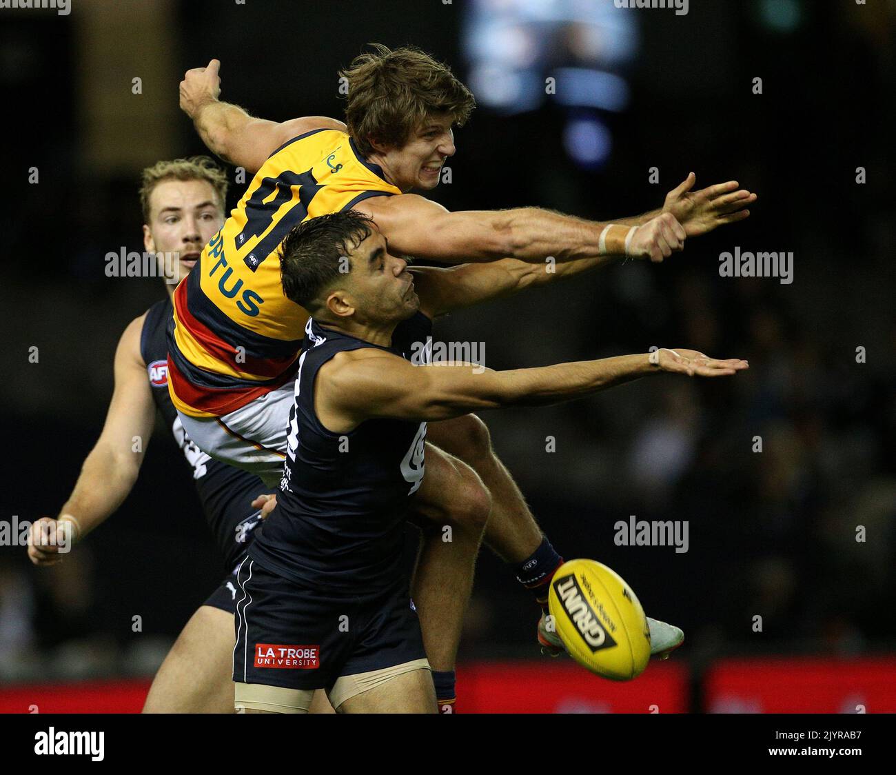 Jordon Butts of the Crows (top) contests with Jack Martin of the Blues ...