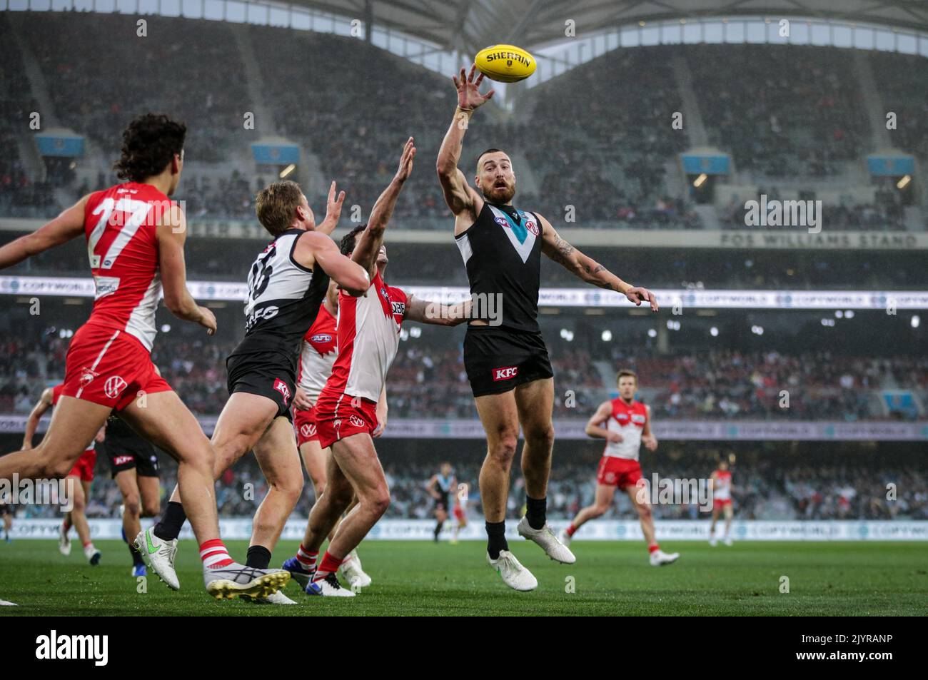 Charlie Dixon of the Power under pressure from Tom McCartin of the ...