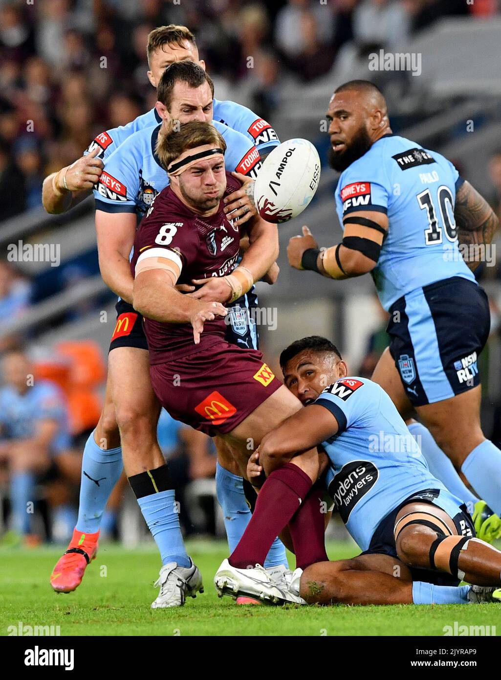 Christian Welch (centre) of the Maroons offloads during Game 2 of the ...