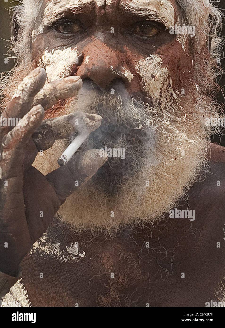An Aboriginal man smokes a cigarette at a Dance Festival in Laura ...