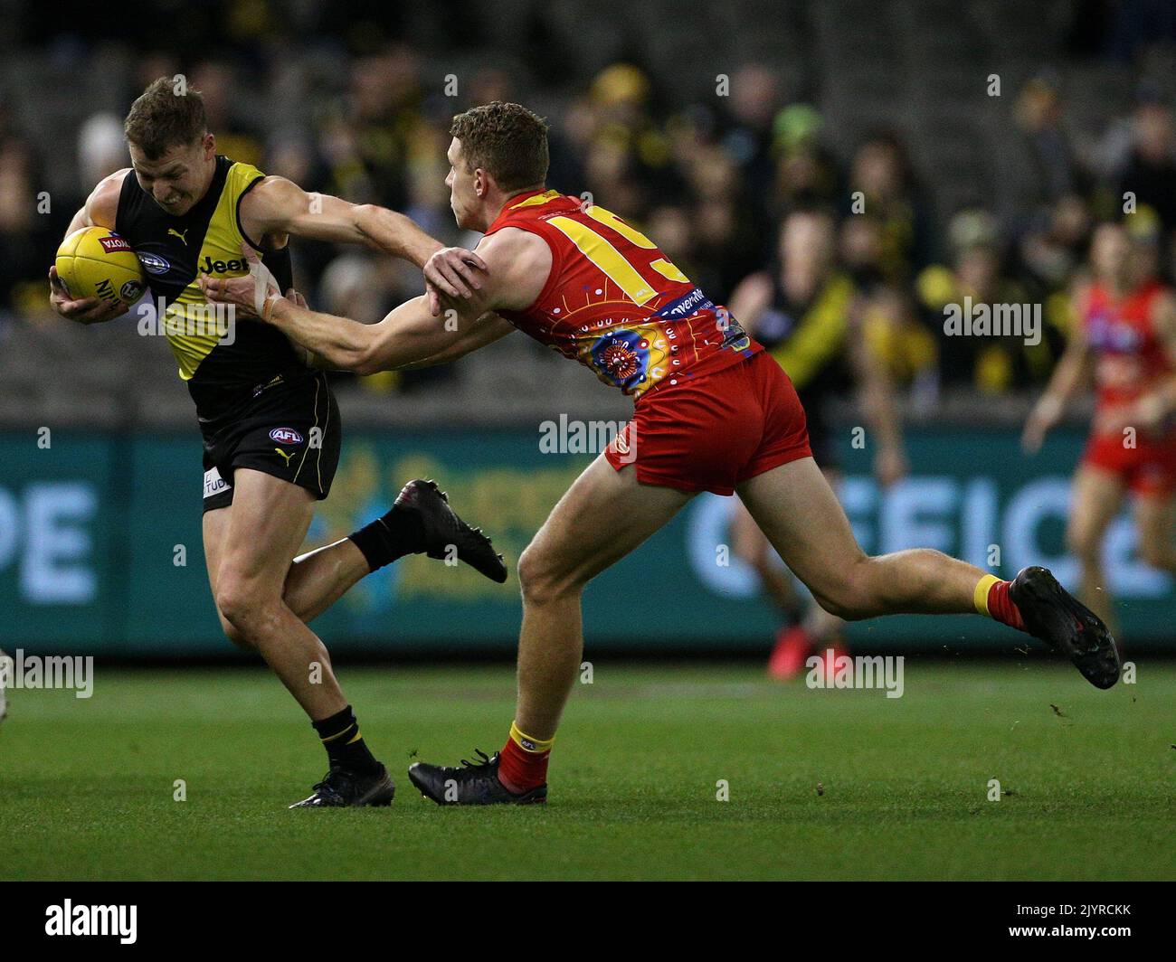 Jake Aarts of the Tigers is tackled by Josh Corbett of the Suns during ...