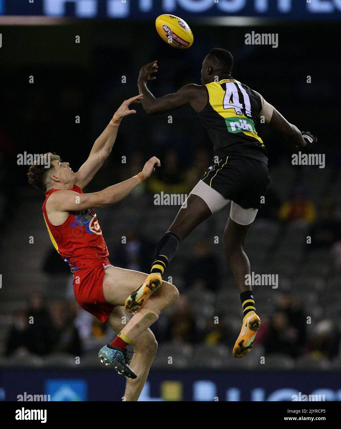 Mabior Chol of the Tigers (right) contests ruck against Chris Burgess ...
