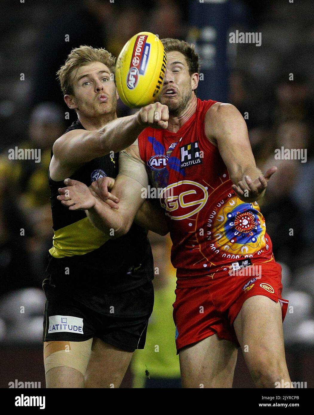 David Astbury of the Tigers (left) contests with Sam Day of the Suns ...