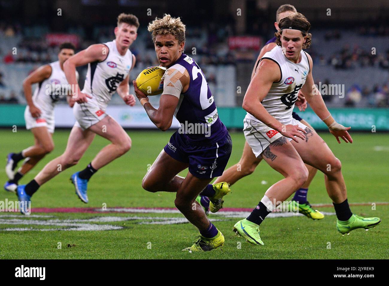 Liam Henry (centre) of the Dockers kicks the footy during the AFL Round ...