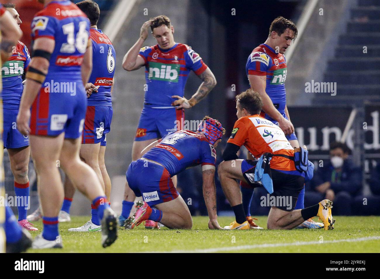 Kalyn Ponga receives attention for a neck injury during the NRL Round ...