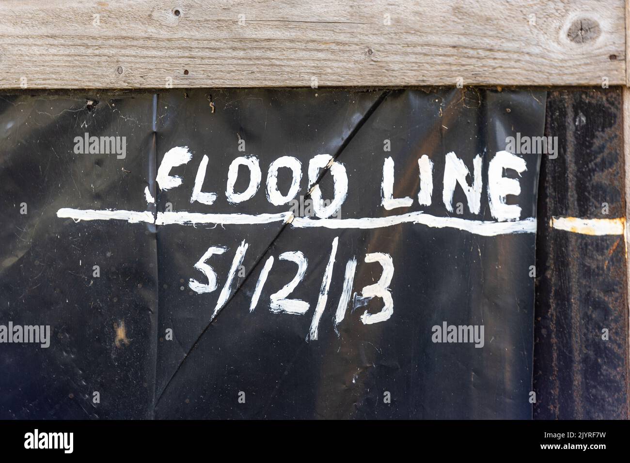 A hand painted sign indicating level of flood water Stock Photo - Alamy