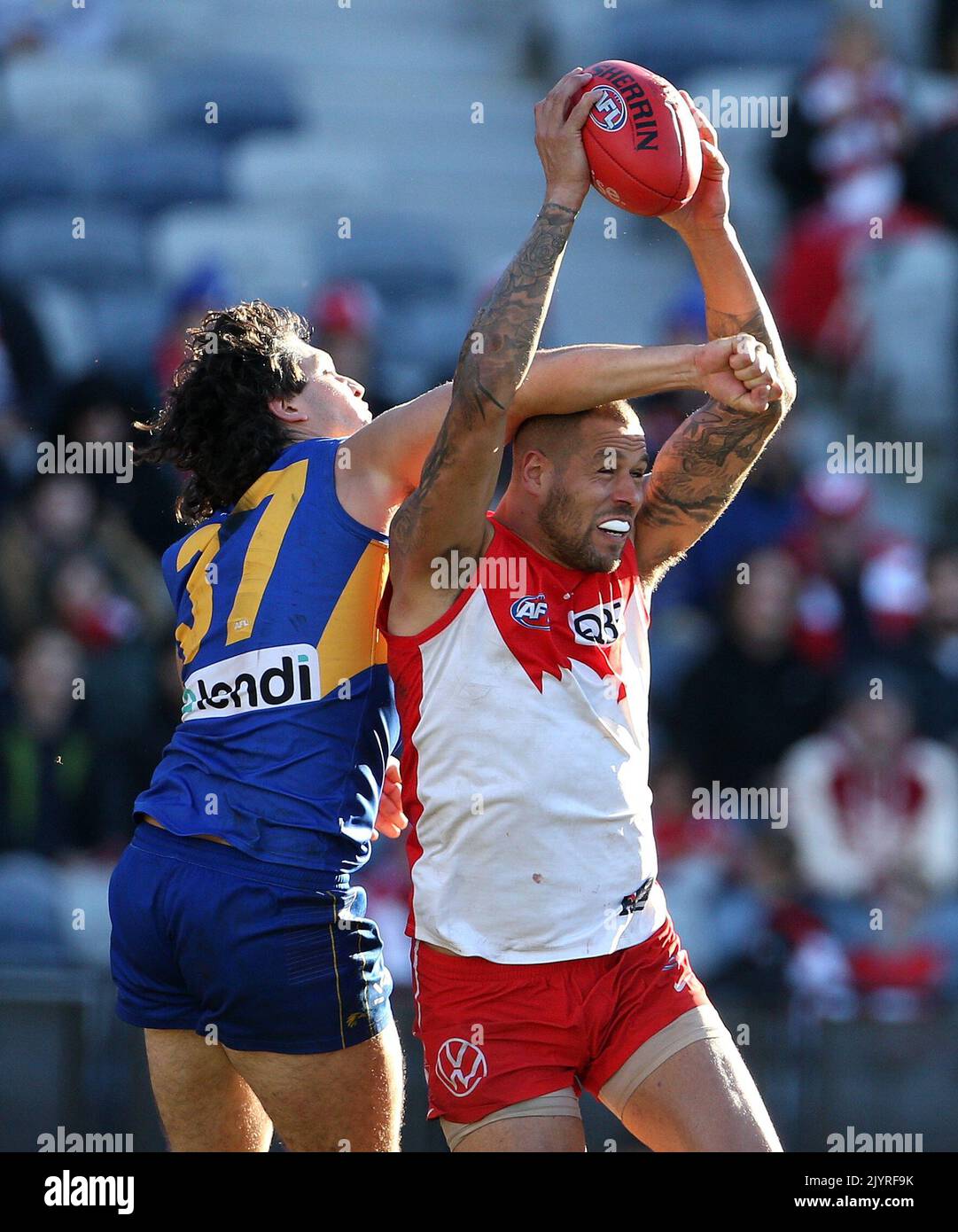 Lance Franklin of the Swans marks under pressure from Tom Barrass of ...