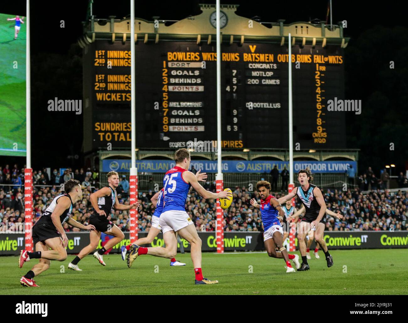 Tom McDonald of the Demons manages to keep the ball in play, turn and ...