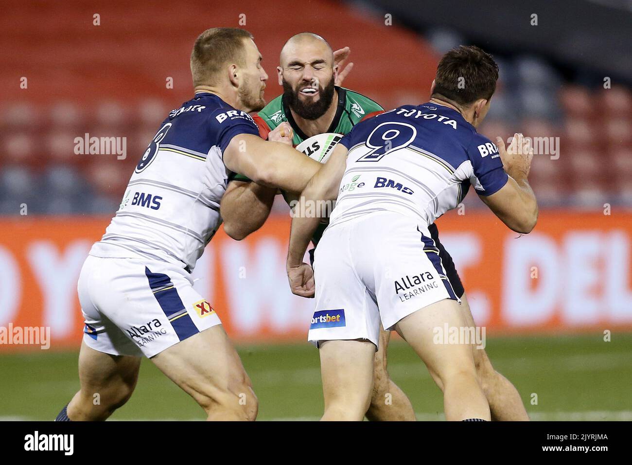 Mark Nicholls of the Rabbitohs hits the Cowboys defence during the ...
