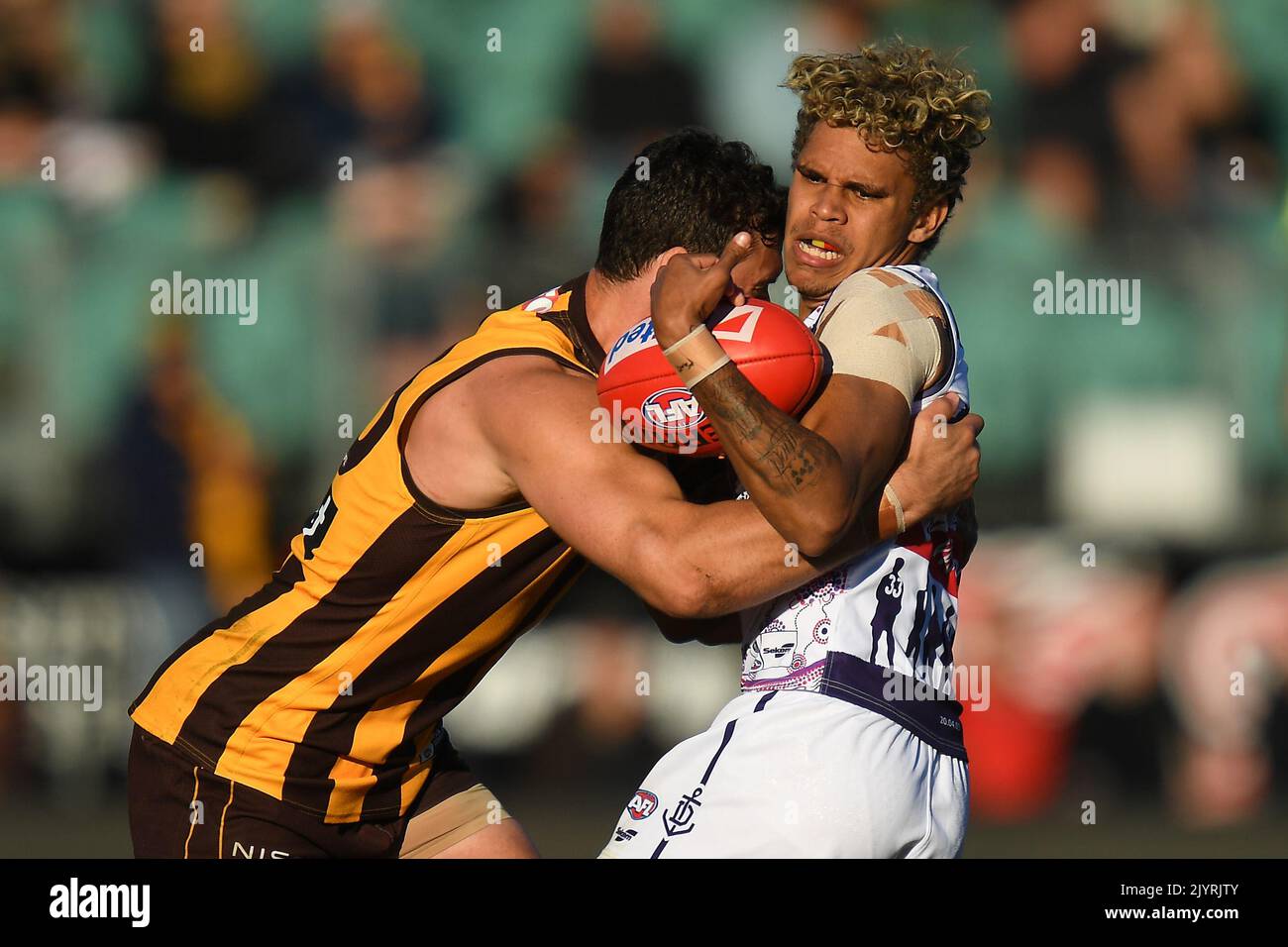 Kyle Hartigan of Hawthorn (left) tackles Liam Henry of the Dockers ...