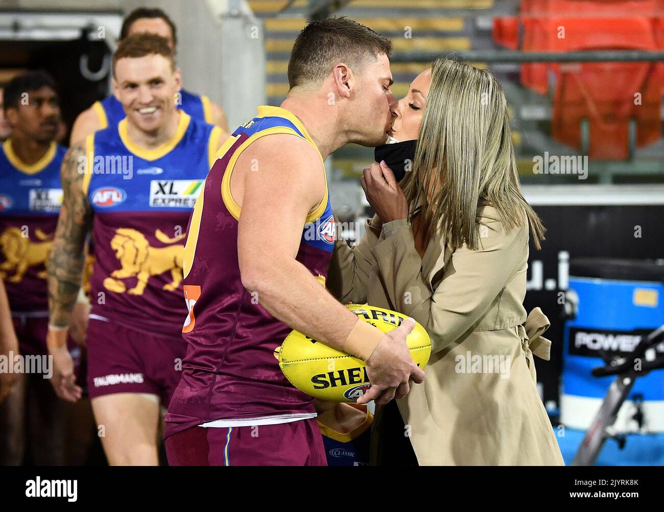 Lions captain Dayne Zorko kisses Talia De Marco as he takes to the ...