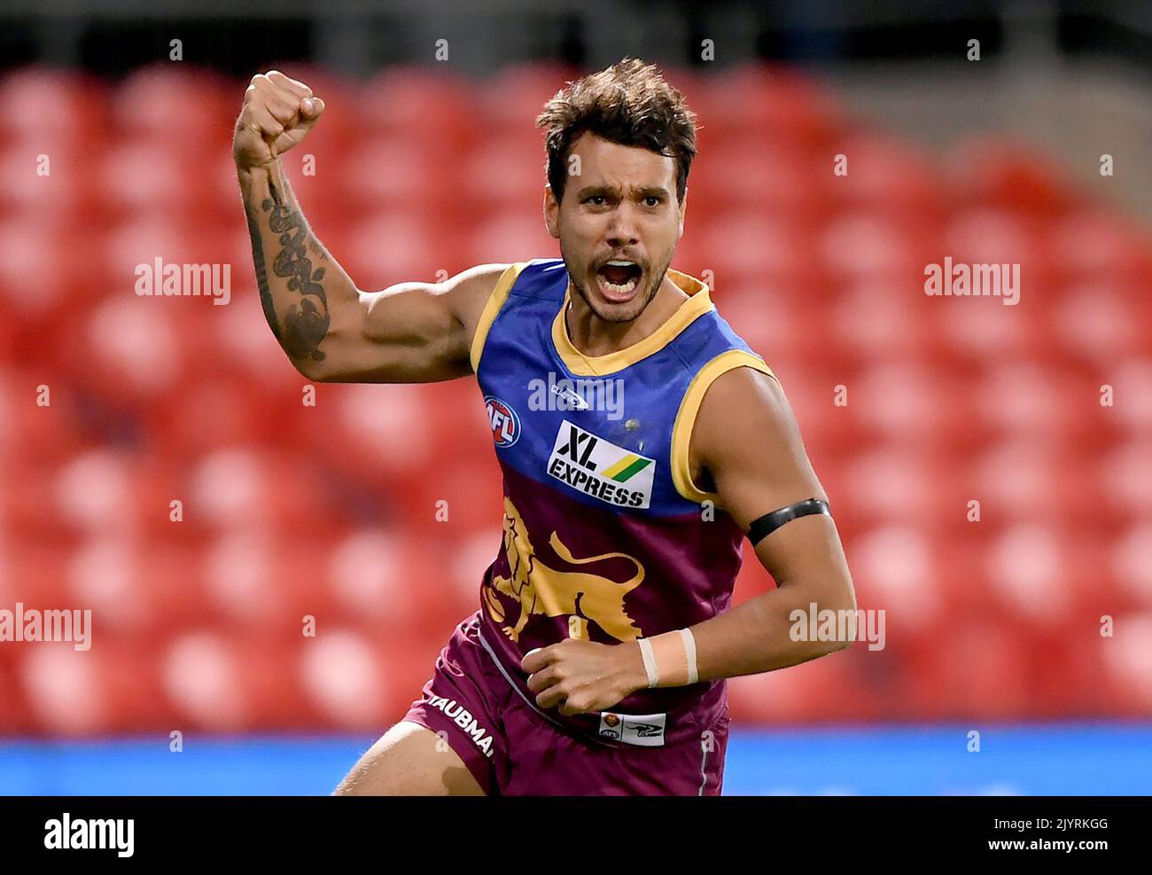 Callum Ah Chee of the Lions reacts after kicking a goal during the AFL ...
