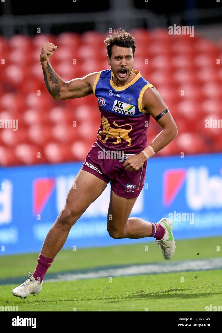 Callum Ah Chee of the Lions reacts after kicking a goal during the AFL ...