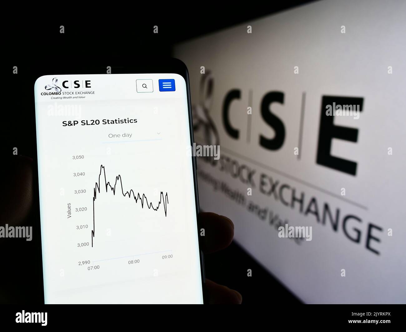 Person holding cellphone with webpage of marketplace Colombo Stock ...