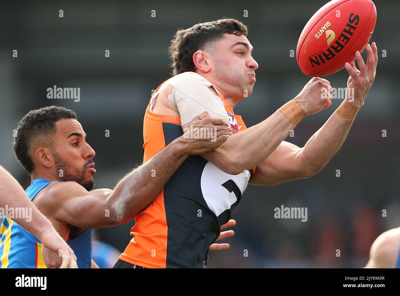 Tim Taranto of the Giants under pressure from Touk Miller of the Suns ...
