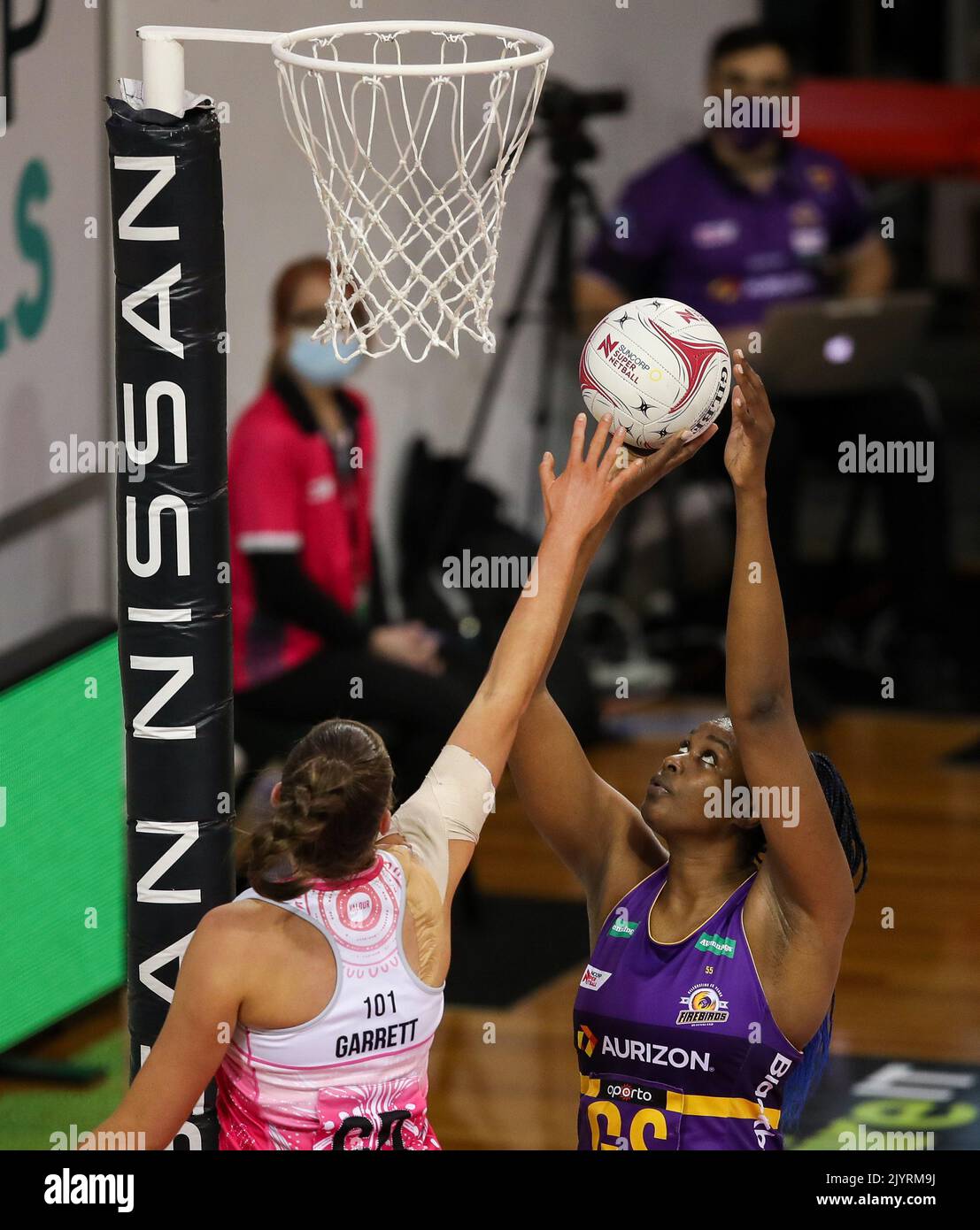 Romelda Aiken of the Firebirds shoots over Matilda Garrett of the ...