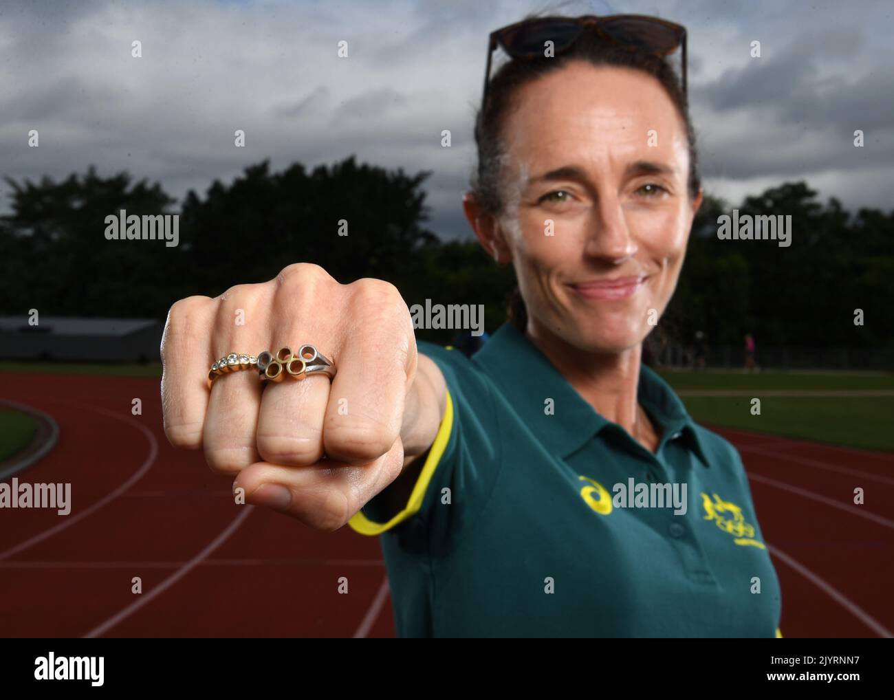 A ring made up of the Olympic rings is seen on the hand of Marathon ...